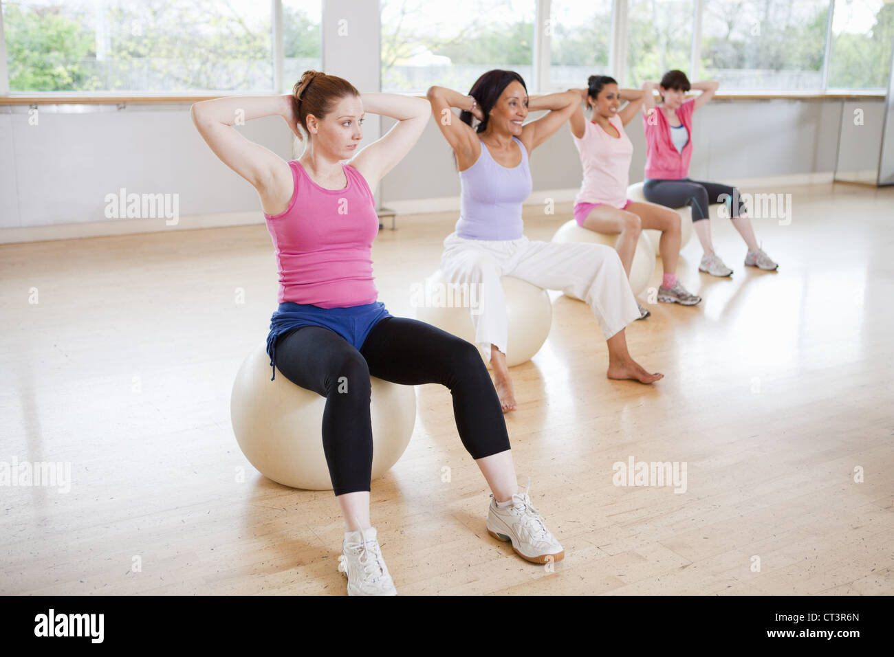 Women on exercise balls in gym class Stock Photo - Alamy