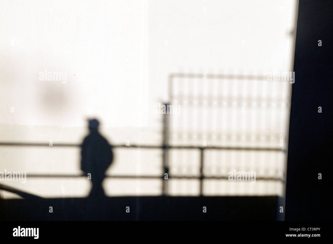 shadow of the passerby man going along the fence Stock Photo - Alamy