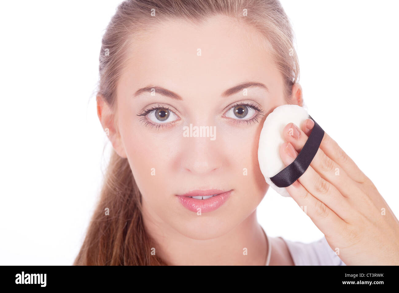 young beautiful woman applying mineral powder on face isolated Stock ...