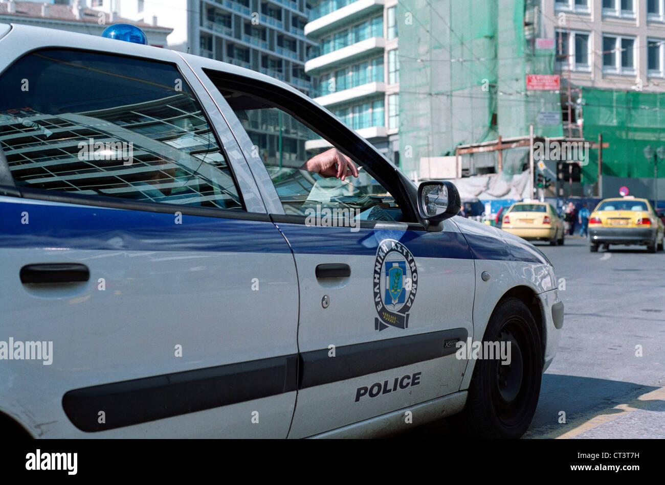 Athens, A police officer in the patrol car smokes Stock Photo - Alamy