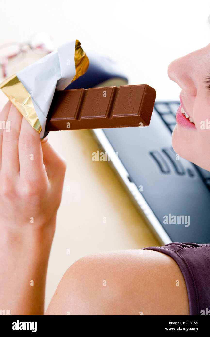 Woman snacking work hi-res stock photography and images - Alamy