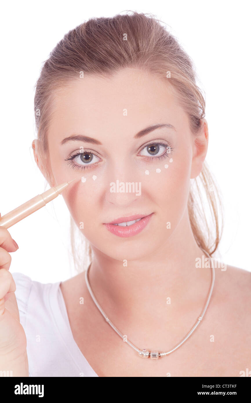 young beautiful woman applying concealer on face isolated Stock Photo ...
