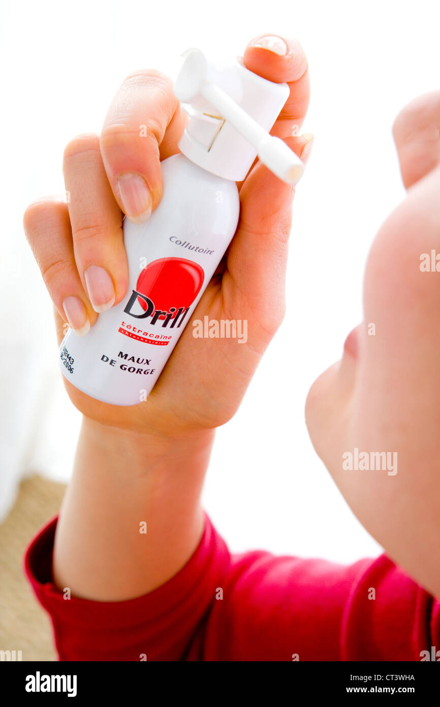 WOMAN USING SPRAY IN MOUTH Stock Photo - Alamy