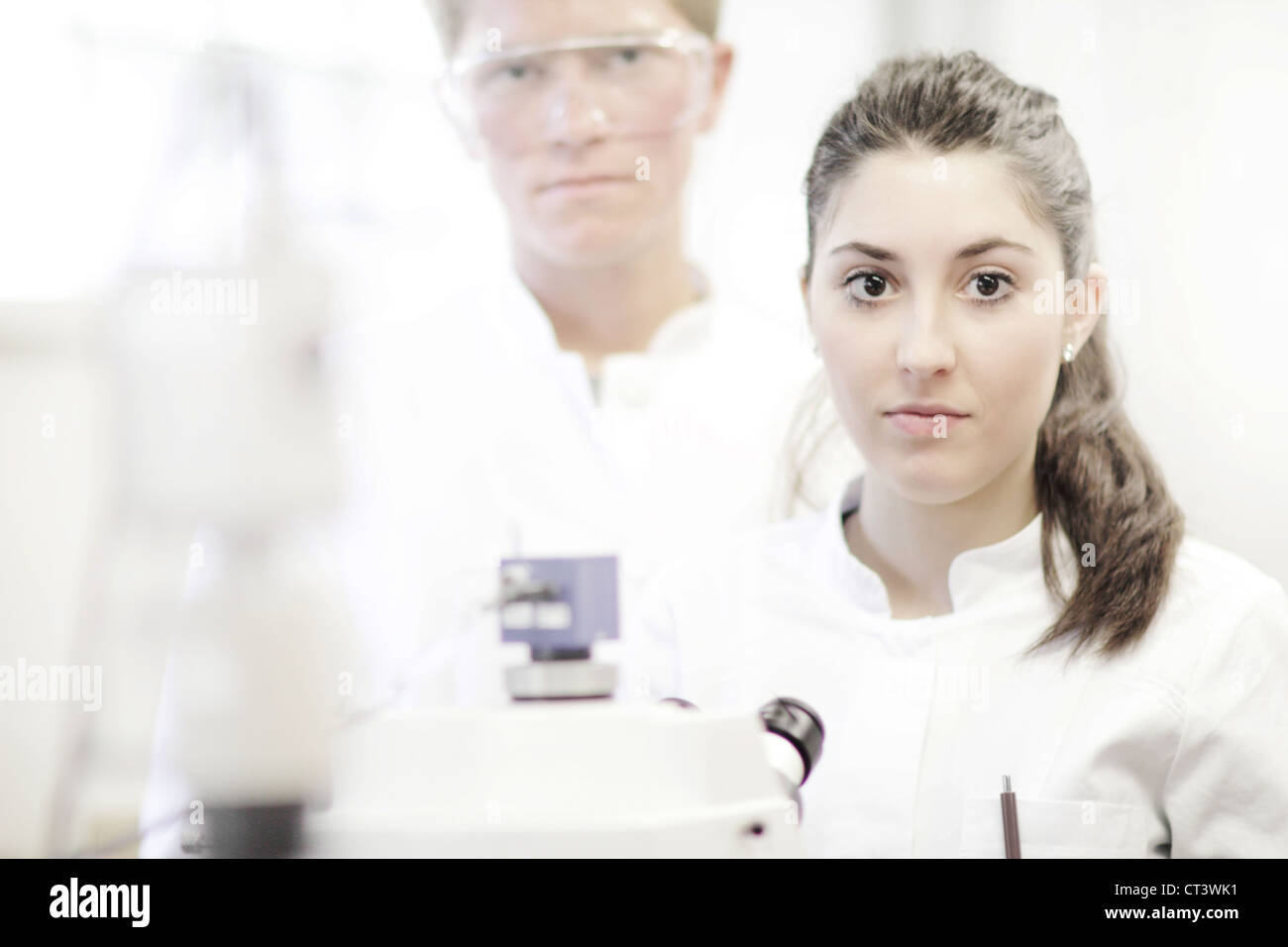Female scientist operating microscope in hi-res stock photography and ...