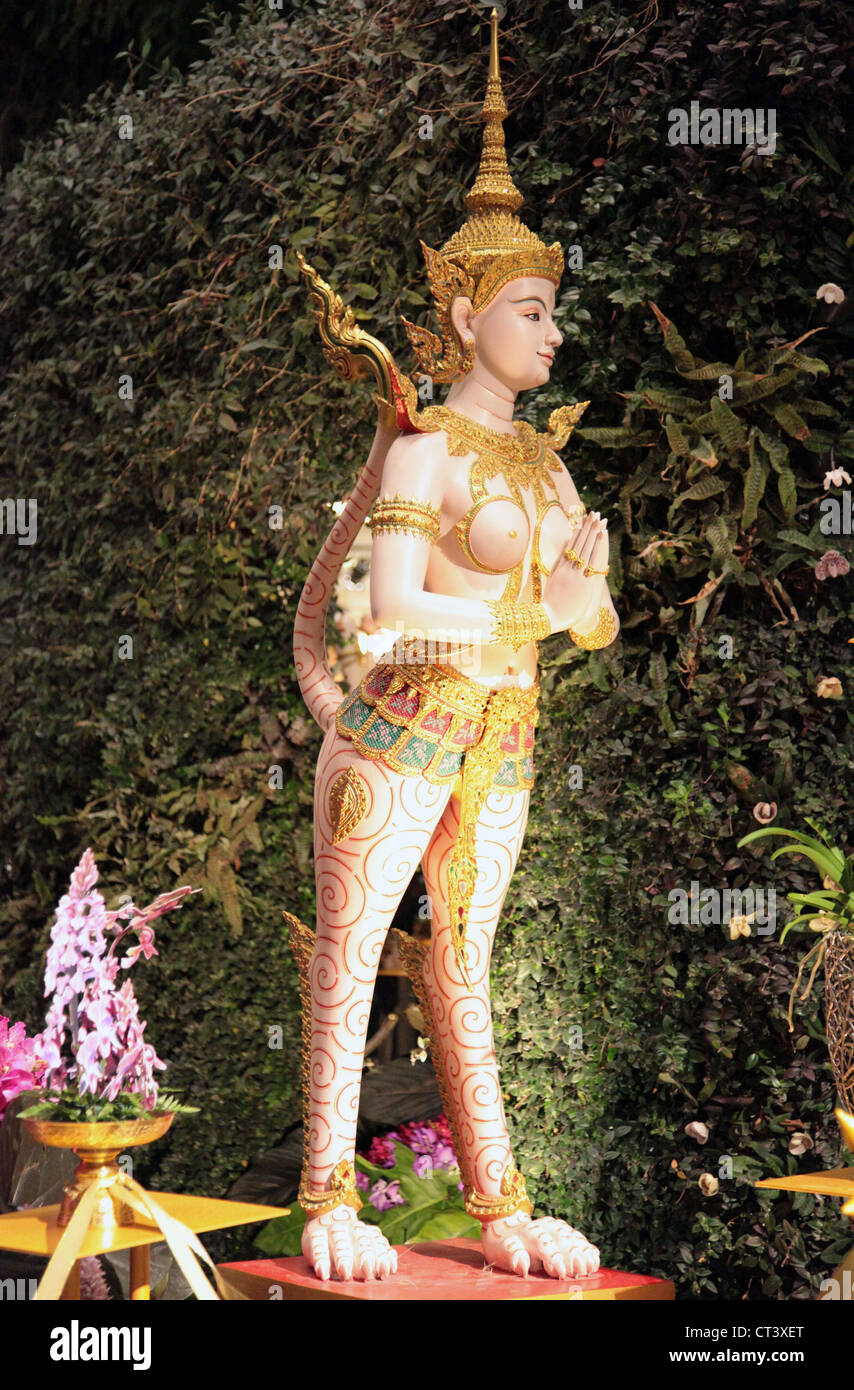 It's a photo of a statue of a Thai God or Goddess. It has a human top ...