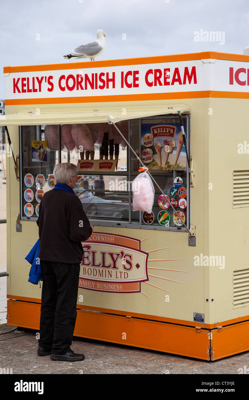 Cornish ice cream kiosk with seagull and customer at St.Ives harbour ...