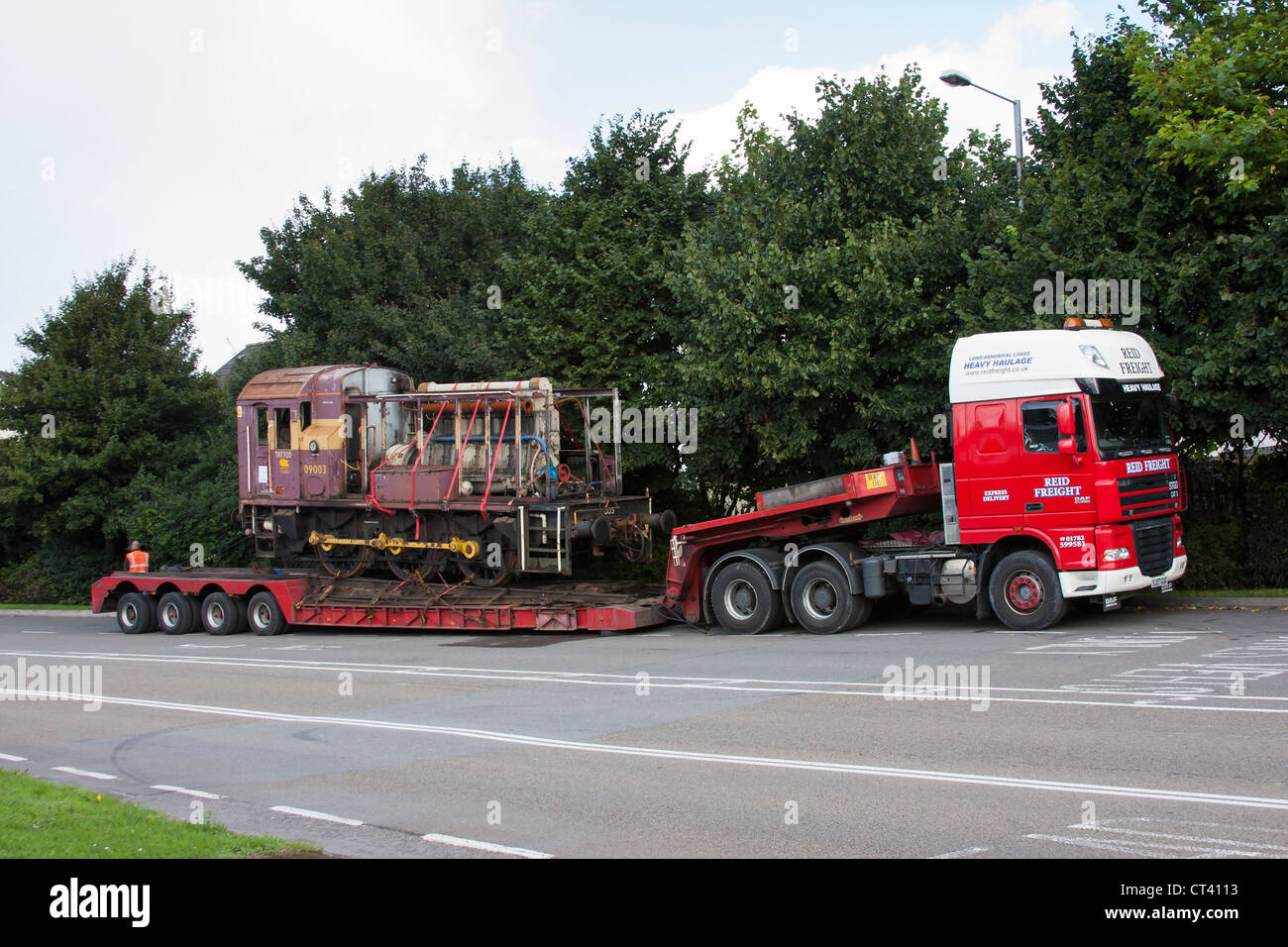 Scrap shunting train engine on low loader truck Stock Photo - Alamy