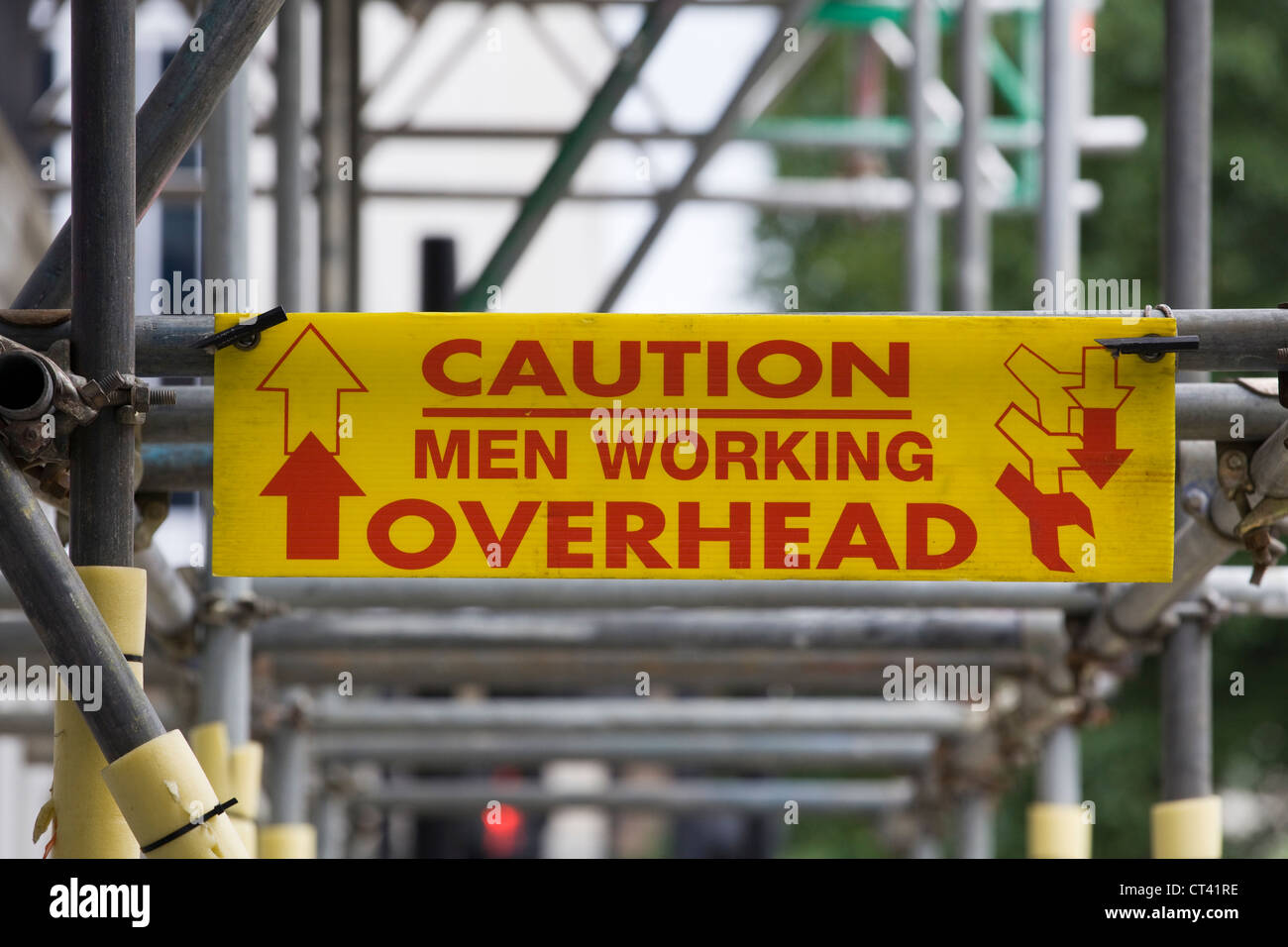 Caution men working overhead sign Stock Photo - Alamy