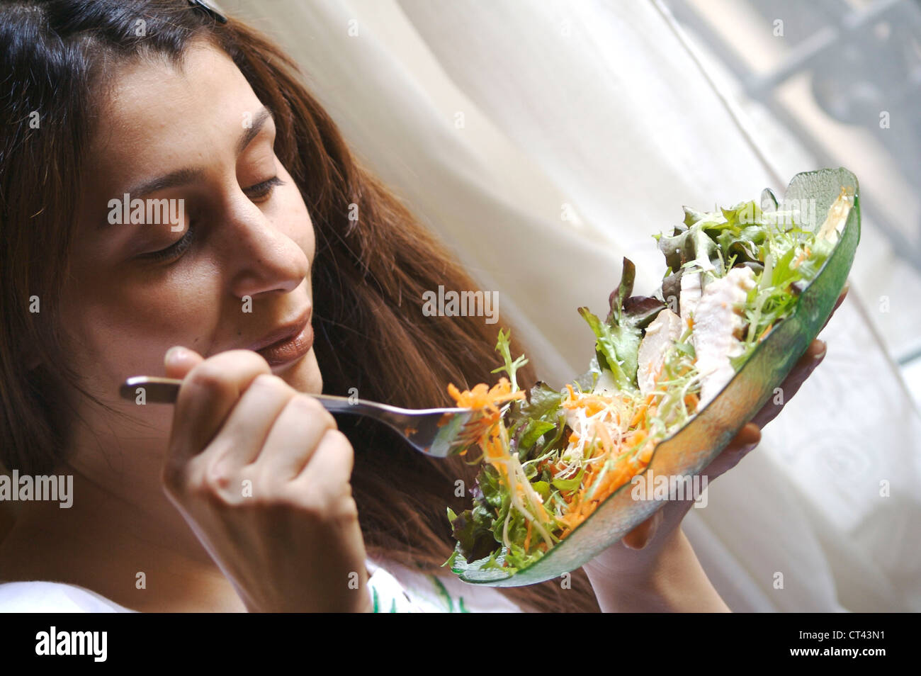 WOMAN EATING RAW VEGETABLES Stock Photo - Alamy