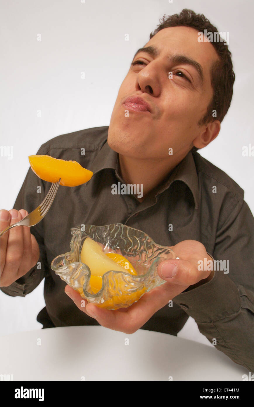 MAN EATING FRUIT Stock Photo - Alamy