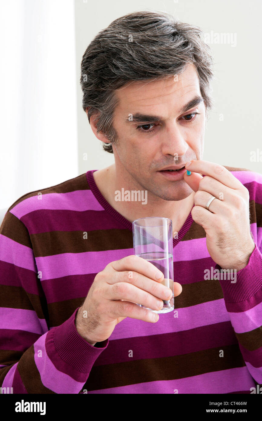 MAN TAKING MEDICATION Stock Photo - Alamy