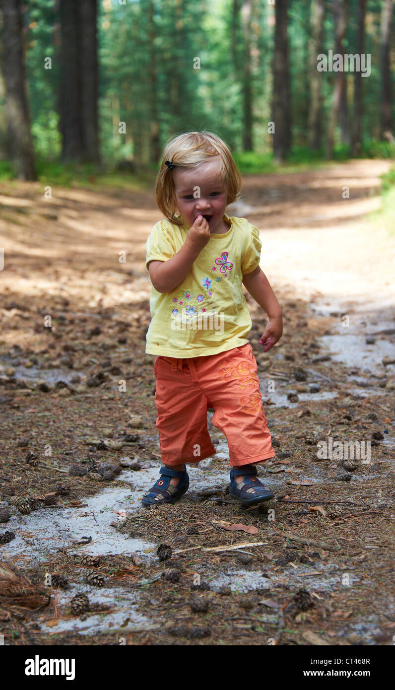 Child baby girl eating blueberries in summer forest Stock Photo - Alamy