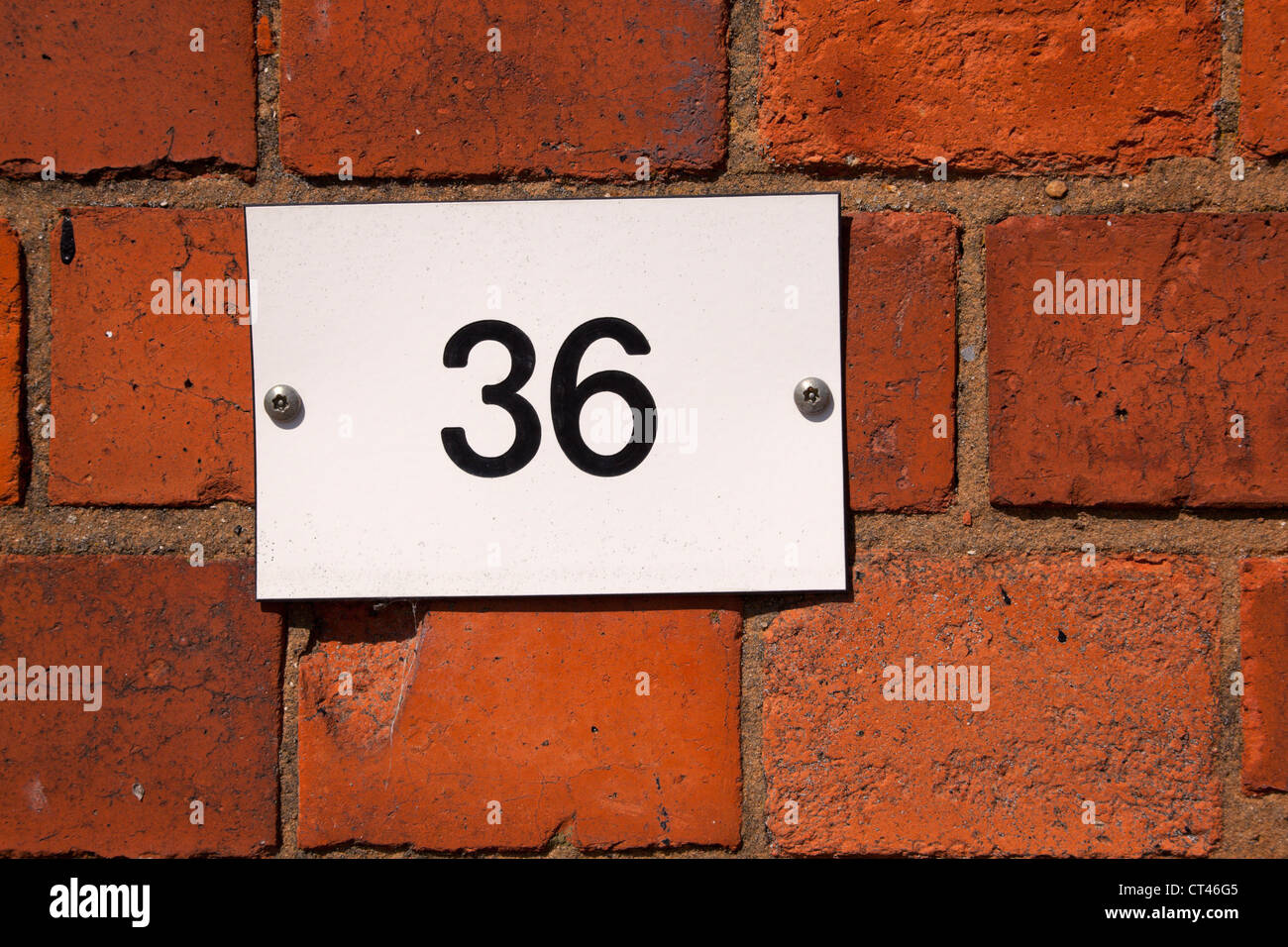 Number "36" on a plate attached to a brick wall Stock Photo - Alamy