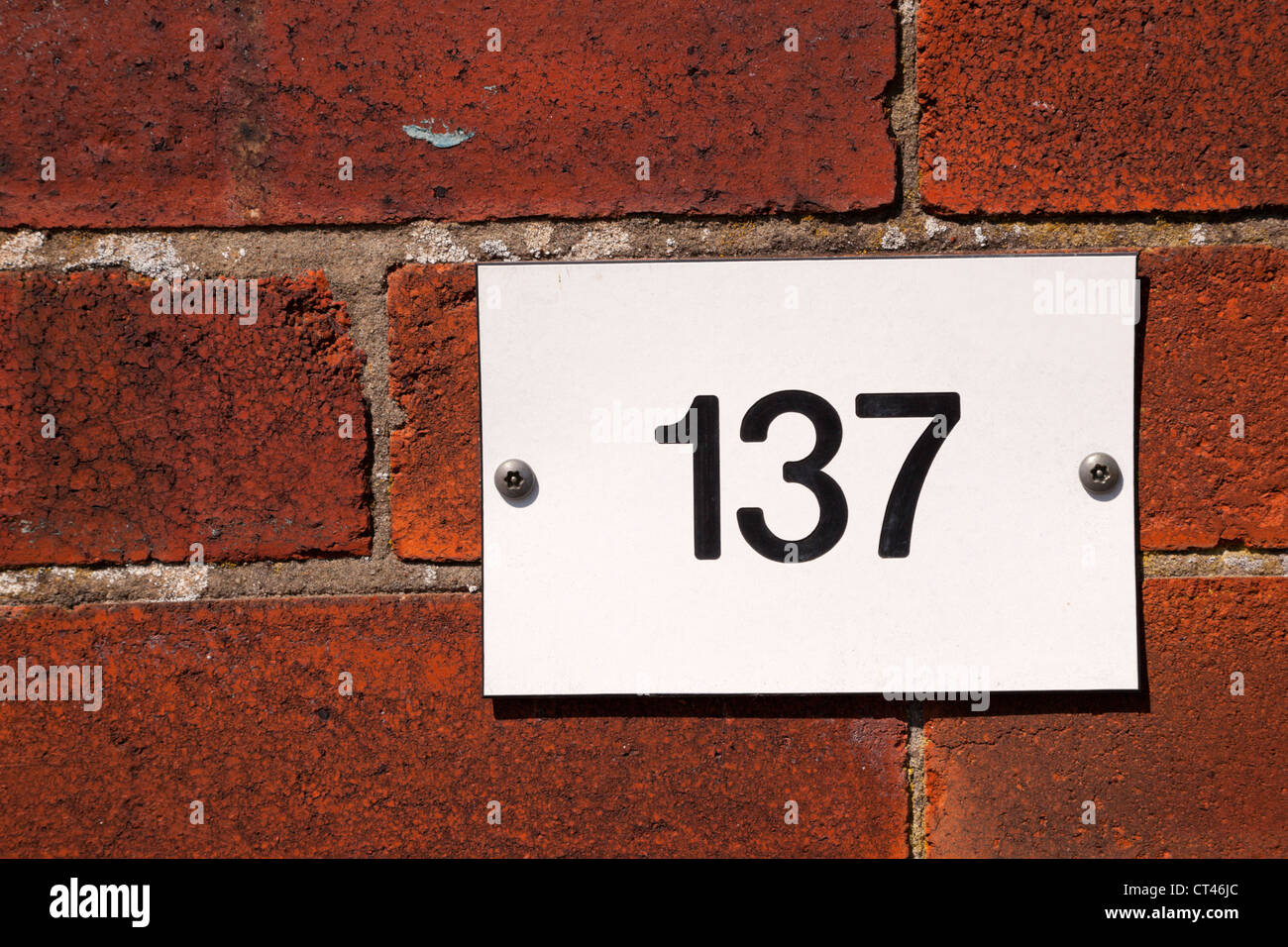 Number "137" on a plate attached to a brick wall Stock Photo - Alamy