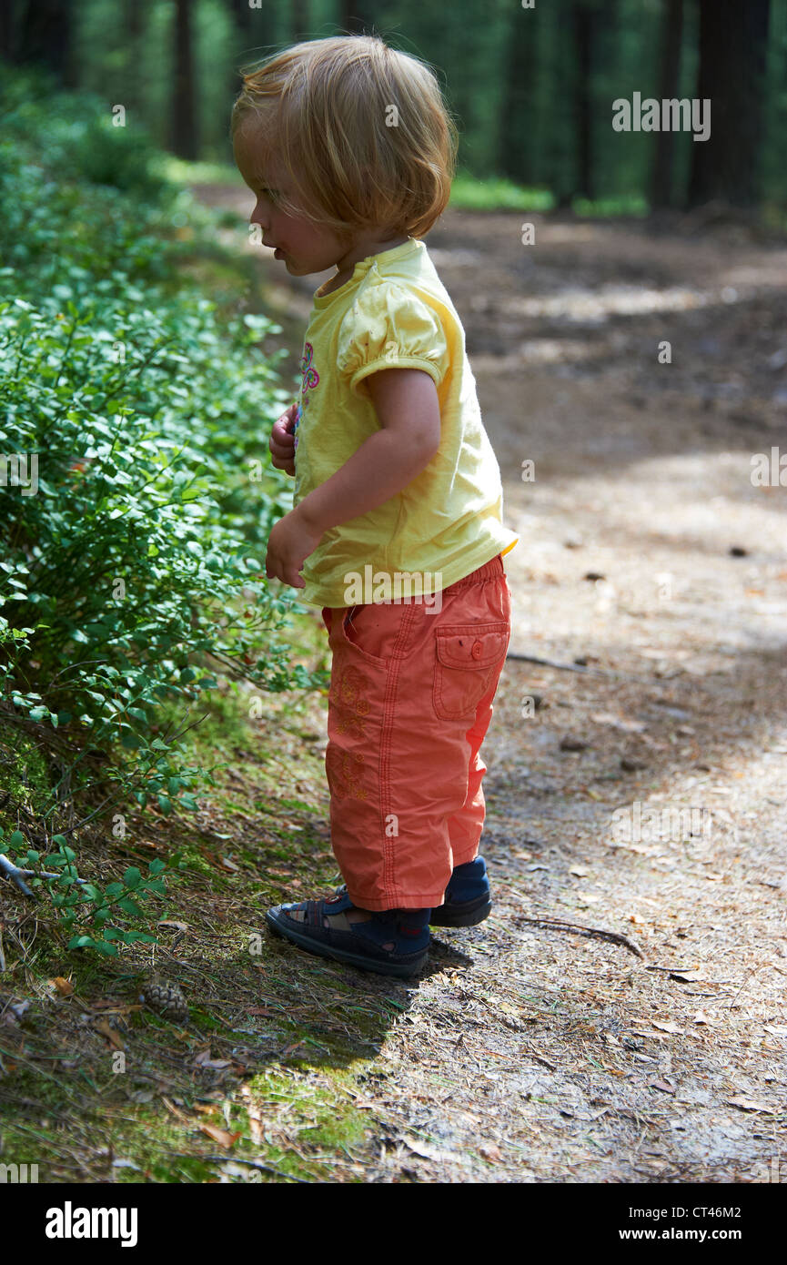 Child baby girl eating blueberries in summer forest Stock Photo - Alamy