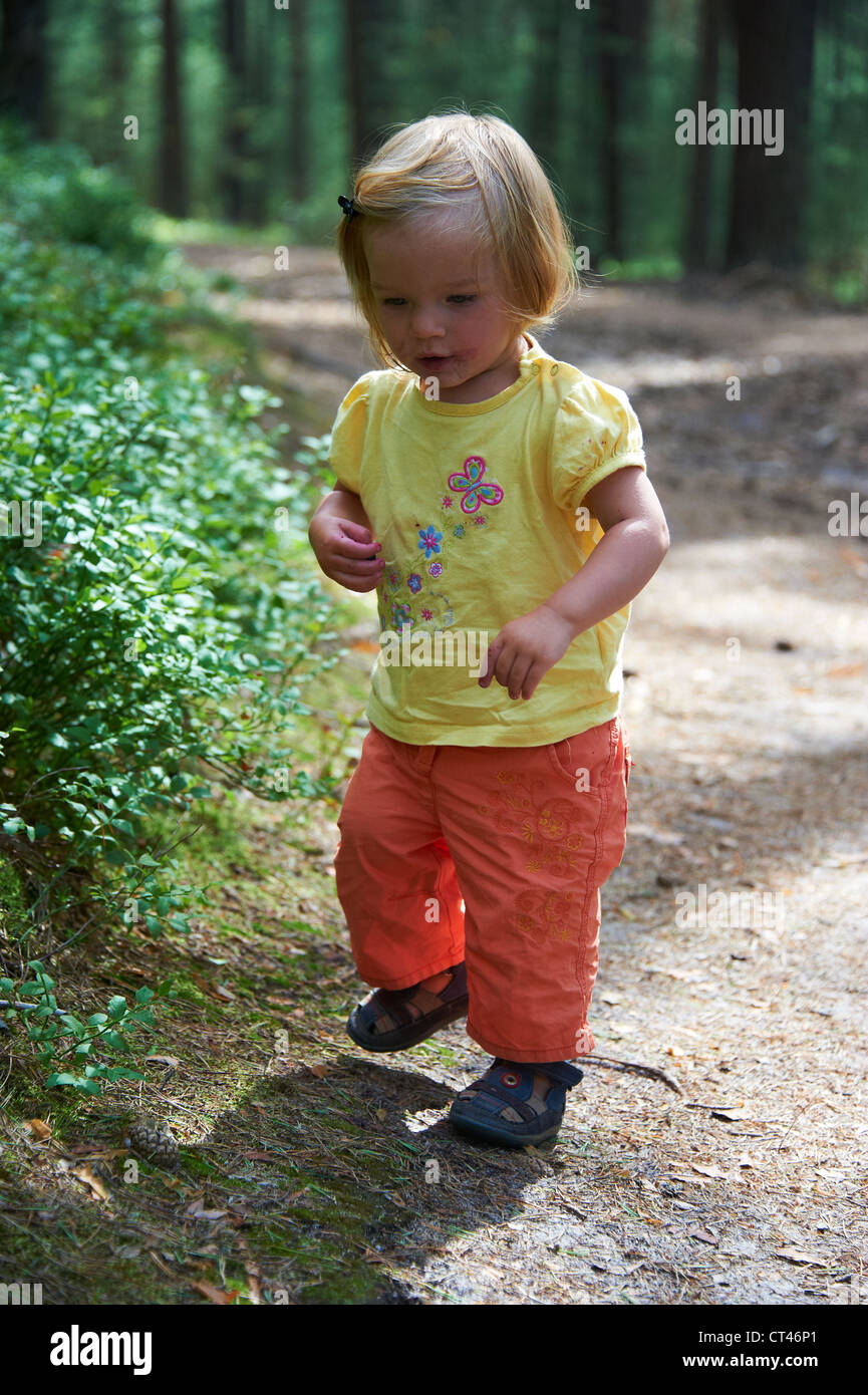 Child baby girl eating blueberries in summer forest Stock Photo - Alamy