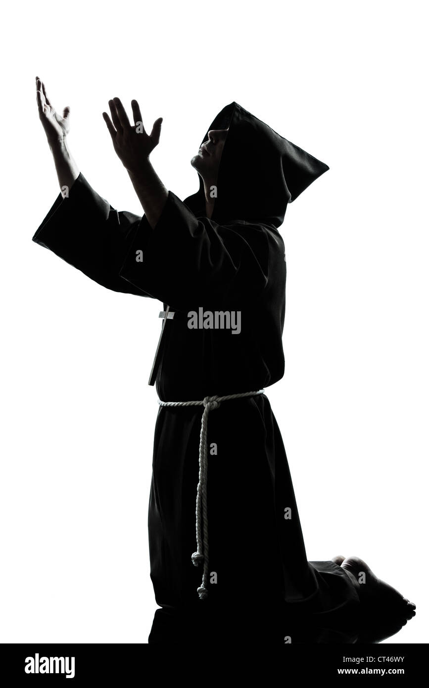 one caucasian man priest praying silhouette in studio isolated on white ...