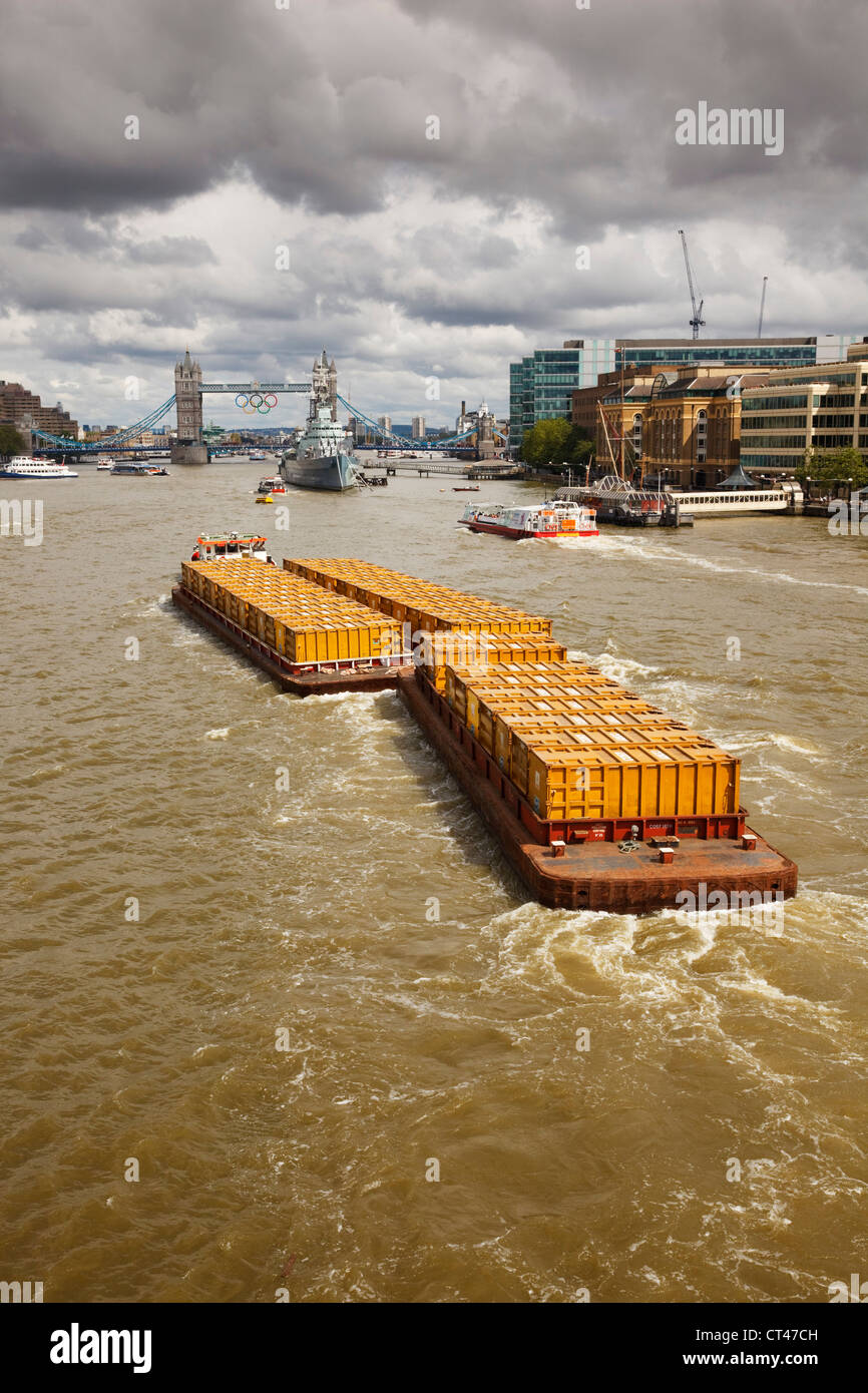 Thames river barge towing containers towards Tower Bridge, London Stock ...