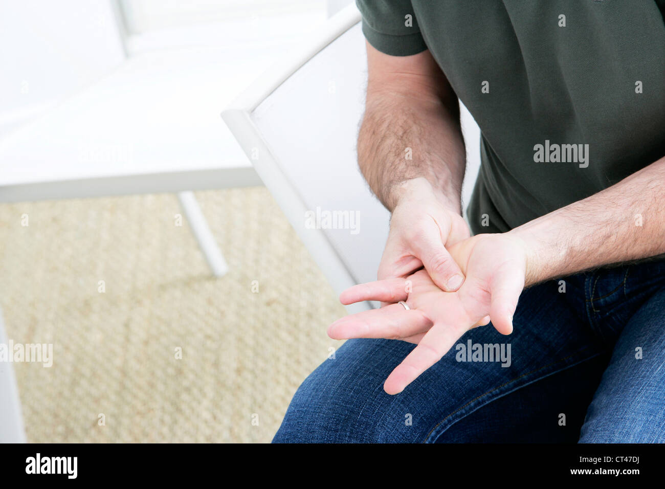 MAN WITH PAINFUL HAND Stock Photo - Alamy