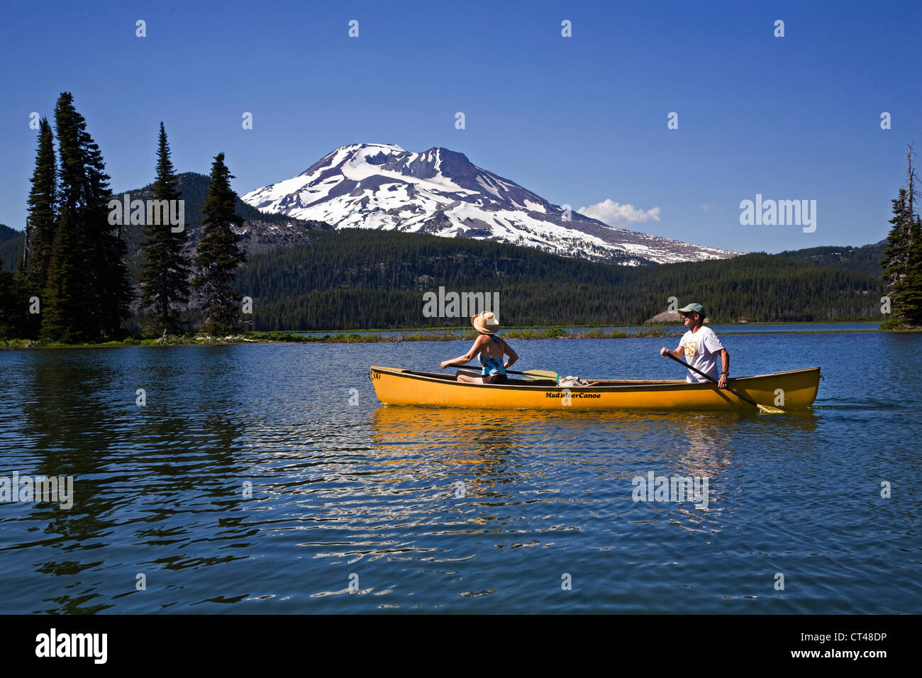 Paddling a canoe on Sparks Lake in the central Oregon Cascades along ...