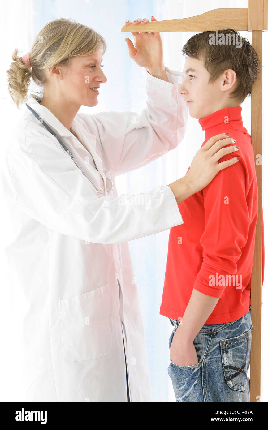 MEASURING HEIGHT, ADOLESCENT Stock Photo - Alamy