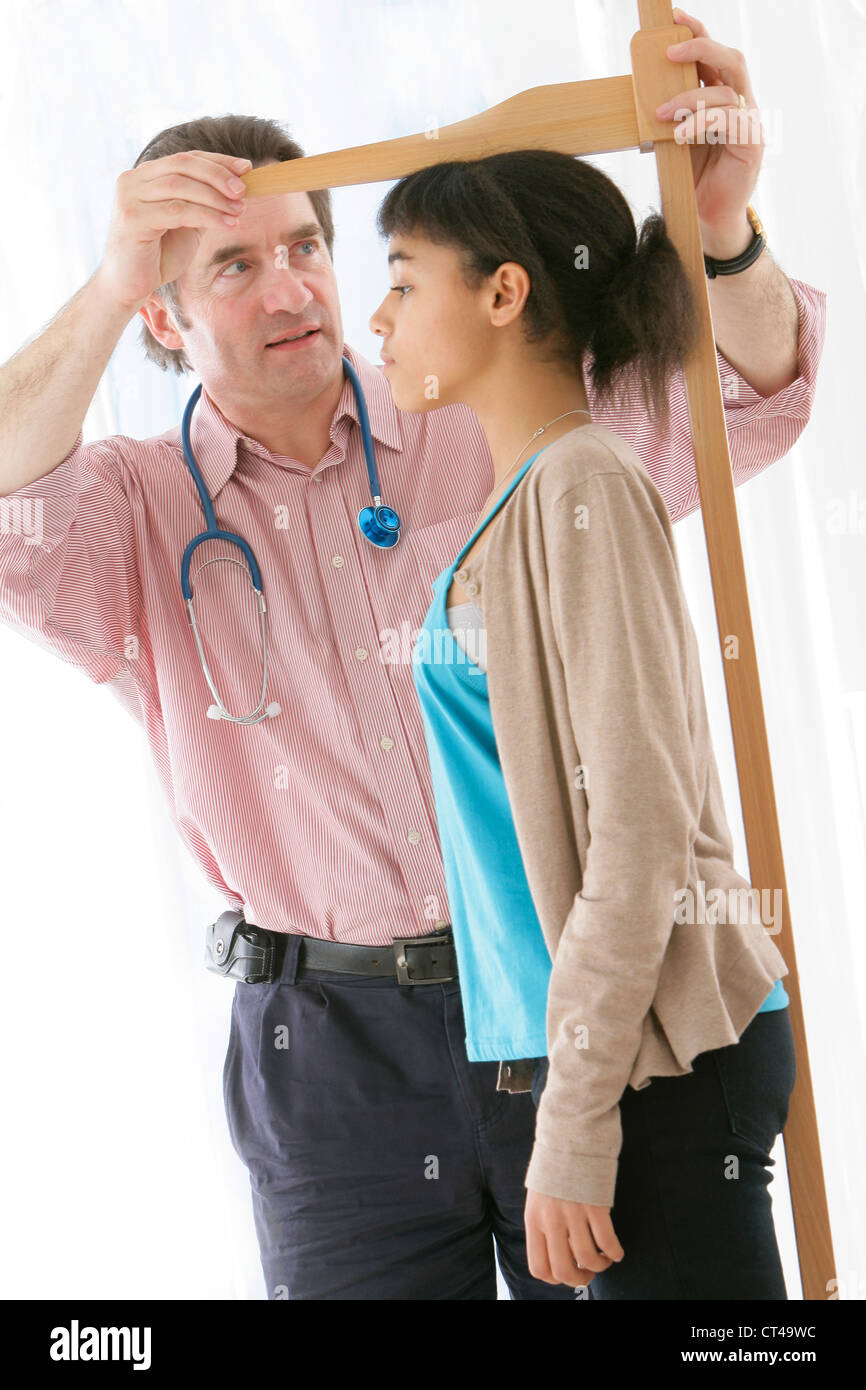 MEASURING HEIGHT, ADOLESCENT Stock Photo - Alamy