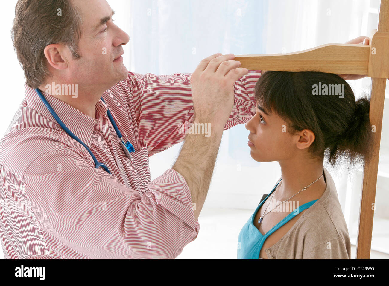 MEASURING HEIGHT, ADOLESCENT Stock Photo - Alamy