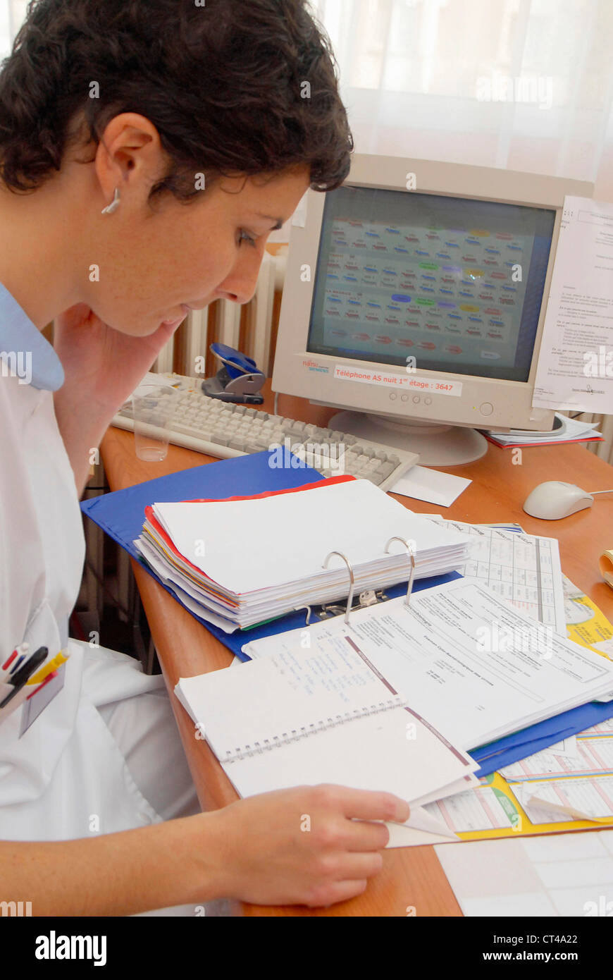 NURSE WITH PATIENT'S RECORD Stock Photo - Alamy
