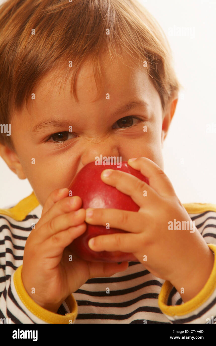 CHILD EATING FRUIT Stock Photo - Alamy