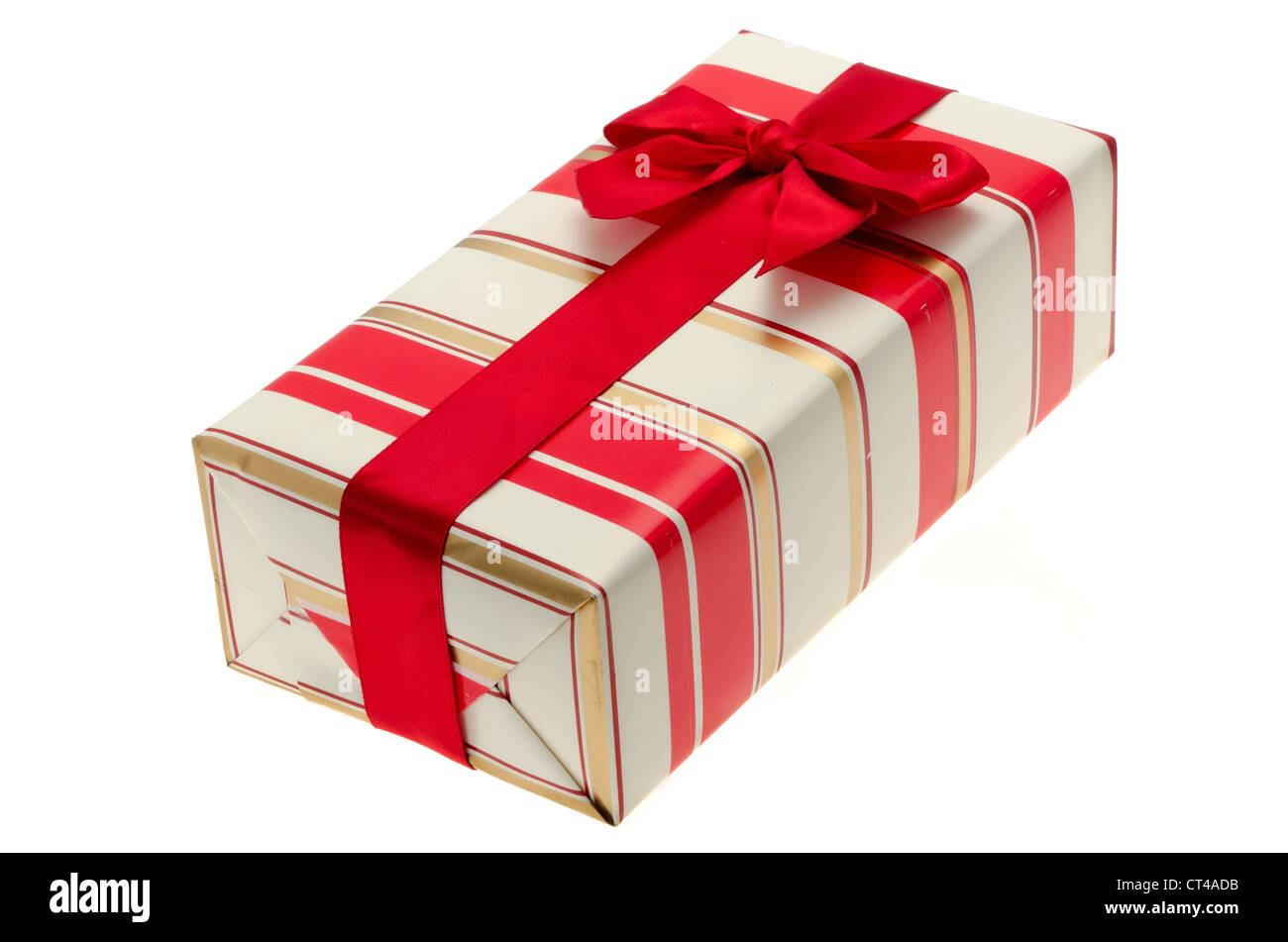 Bright red gift wrapped box with ribbon and bow - studio shot with a ...