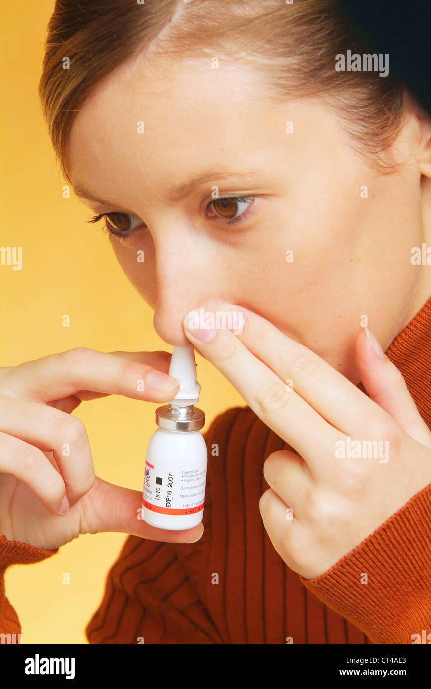 WOMAN USING NOSE SPRAY Stock Photo - Alamy