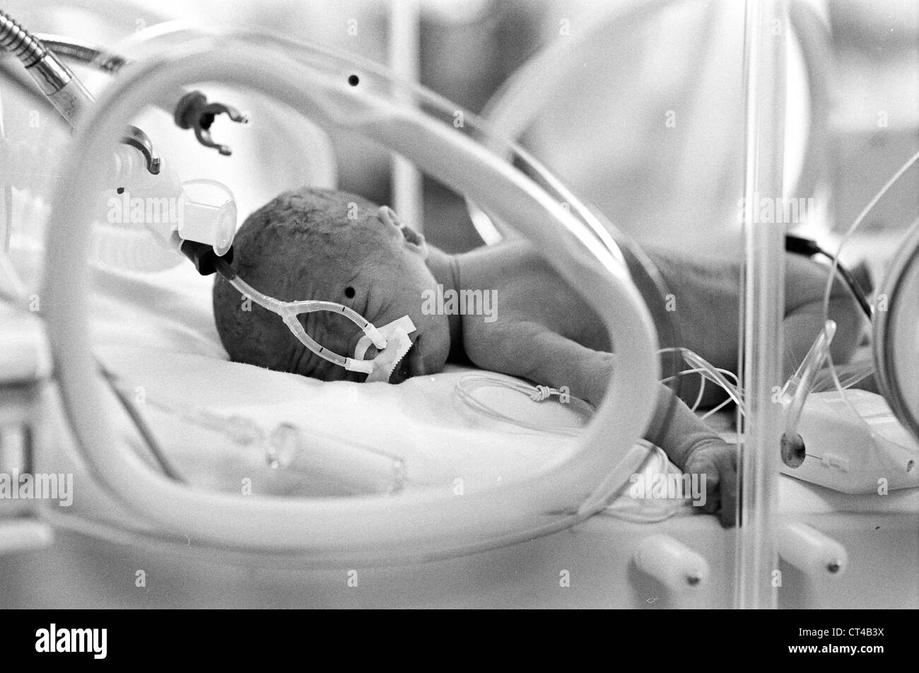 Baby lying in bed Black and White Stock Photos & Images - Alamy
