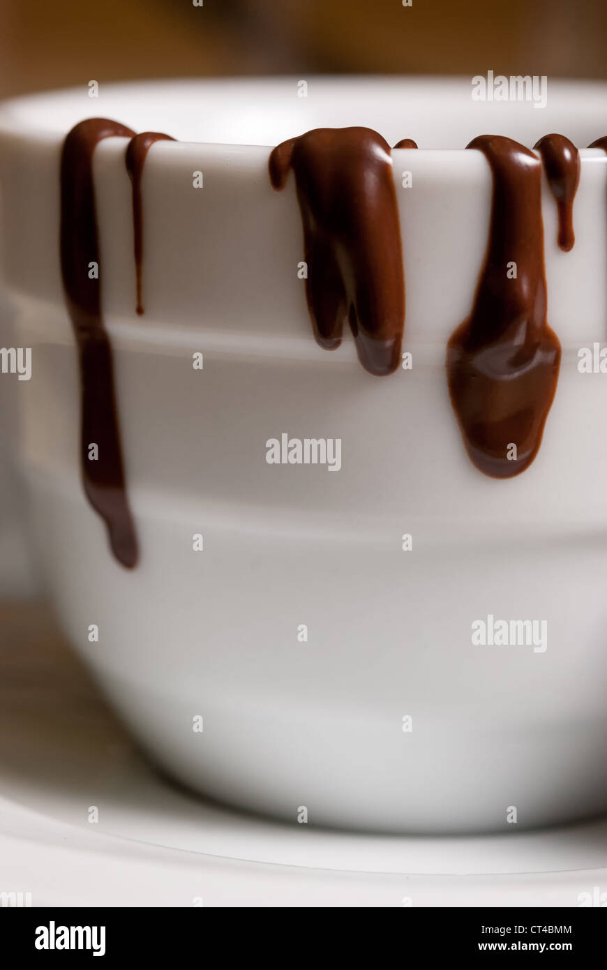 Closeup of White coffee cup with chocolate flowing. Shallow DOF Stock ...