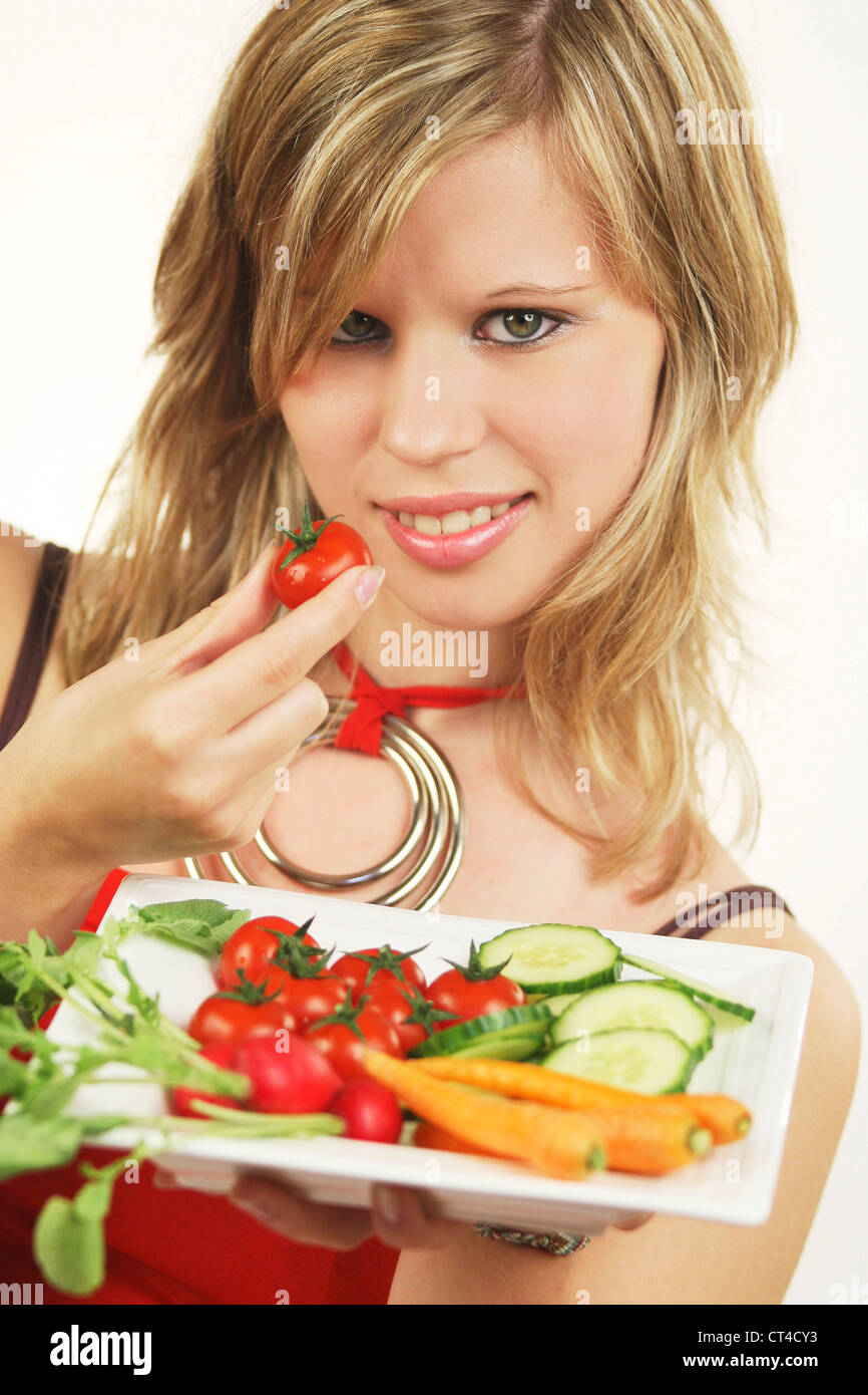 WOMAN EATING RAW VEGETABLES Stock Photo - Alamy