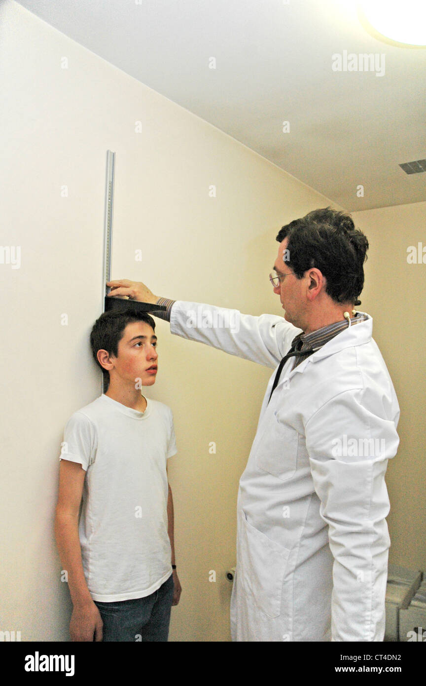 MEASURING HEIGHT, ADOLESCENT Stock Photo - Alamy