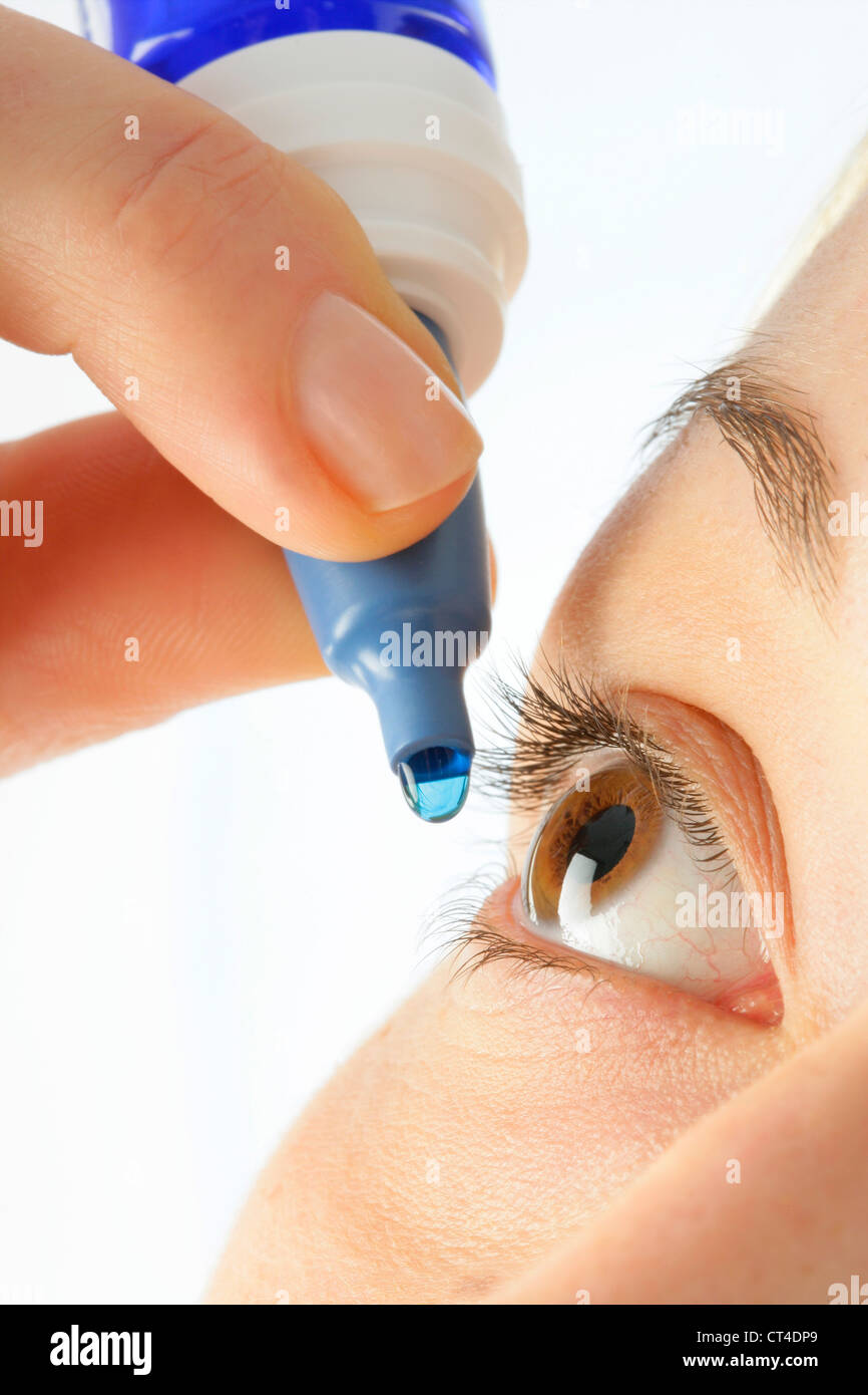 WOMAN USING EYE LOTION Stock Photo - Alamy