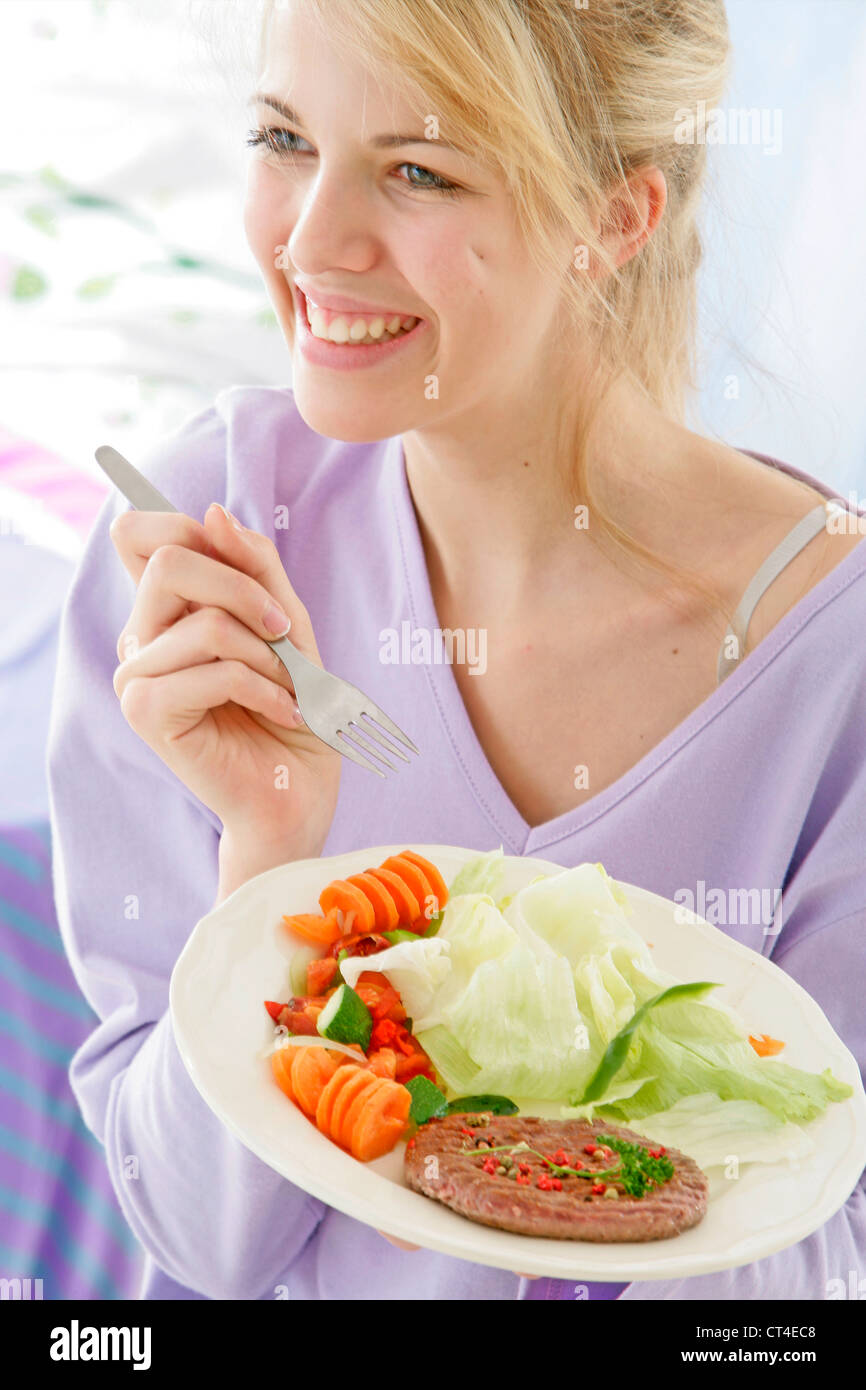 ADOLESCENT EATING A MEAL Stock Photo - Alamy