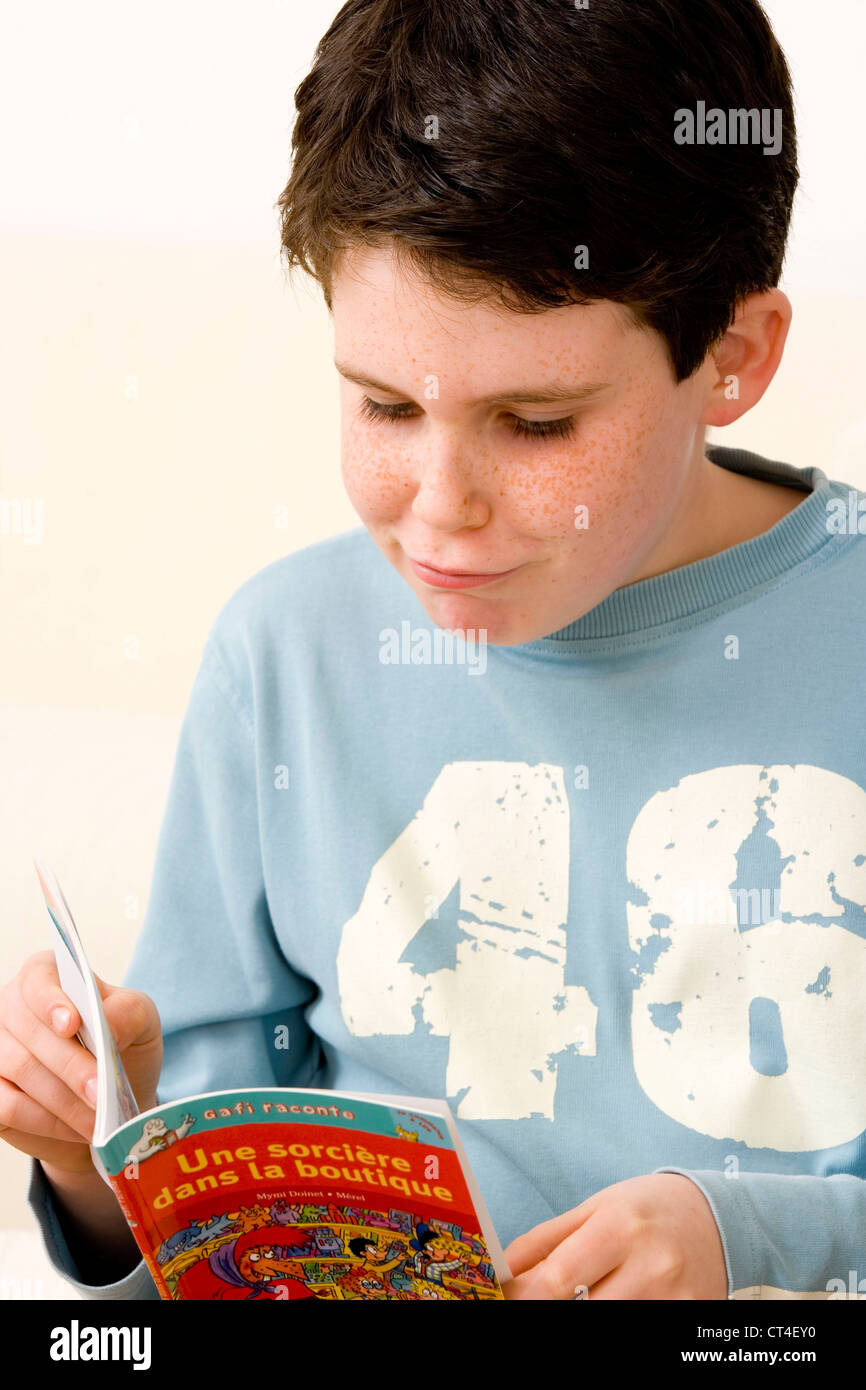 CHILD READING INDOORS Stock Photo - Alamy