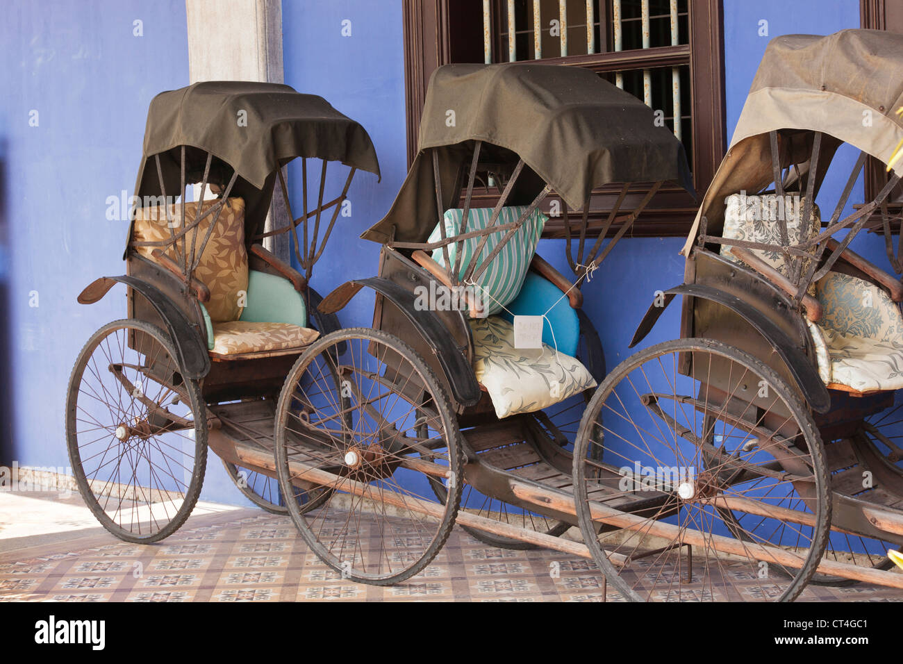 Malaysia, Penang. Traditional rickshaws lined up next to house Stock ...