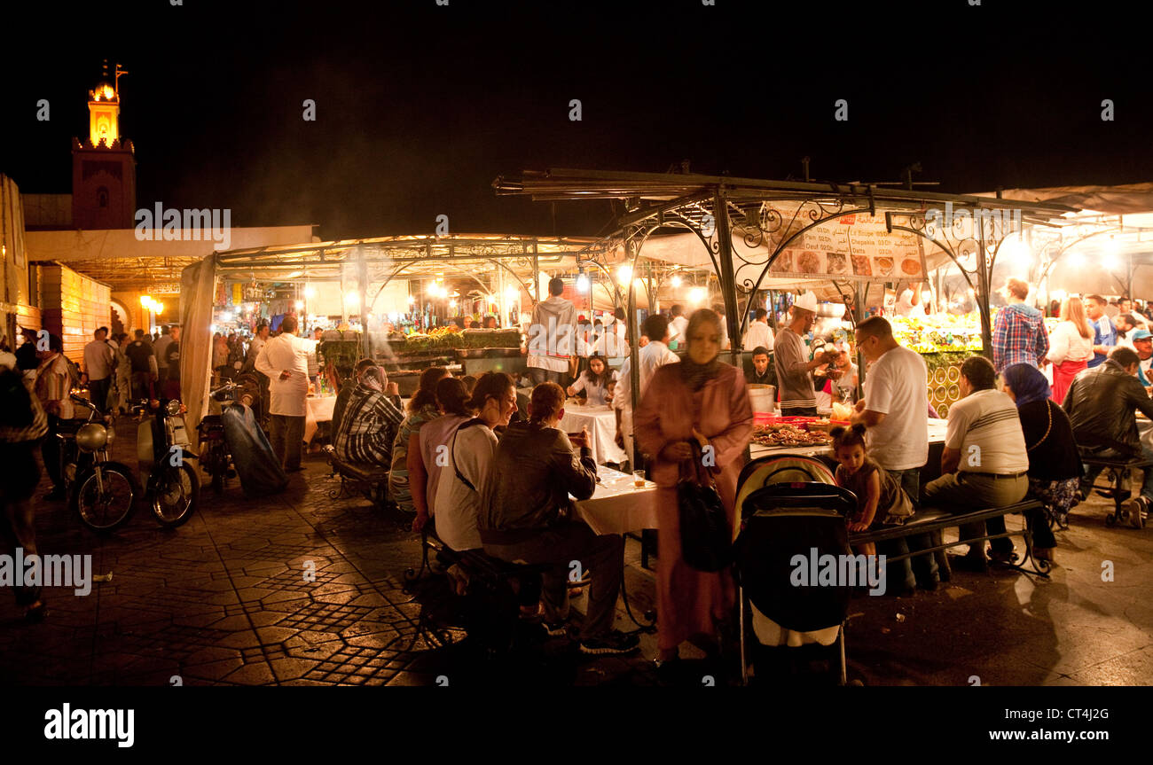 People eating street food at food stalls in Djemaa el Fna square at ...