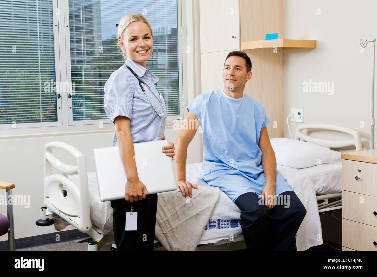 Nurse and patient in hospital ward Stock Photo - Alamy