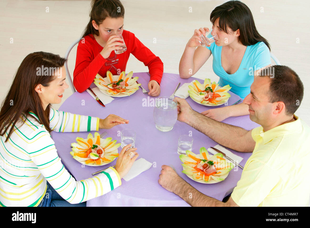 FAMILY EATING A MEAL Stock Photo - Alamy