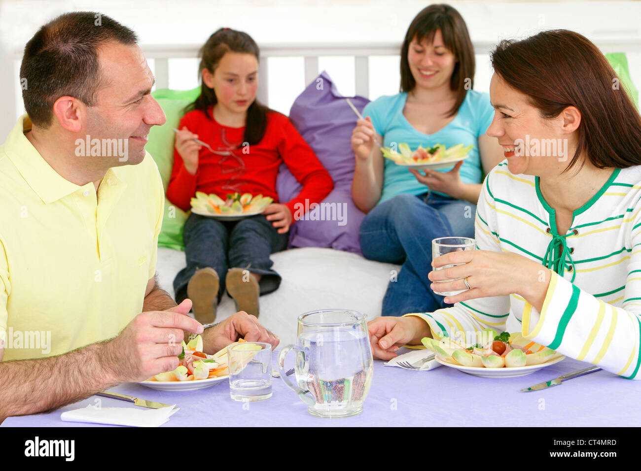 FAMILY EATING A MEAL Stock Photo - Alamy