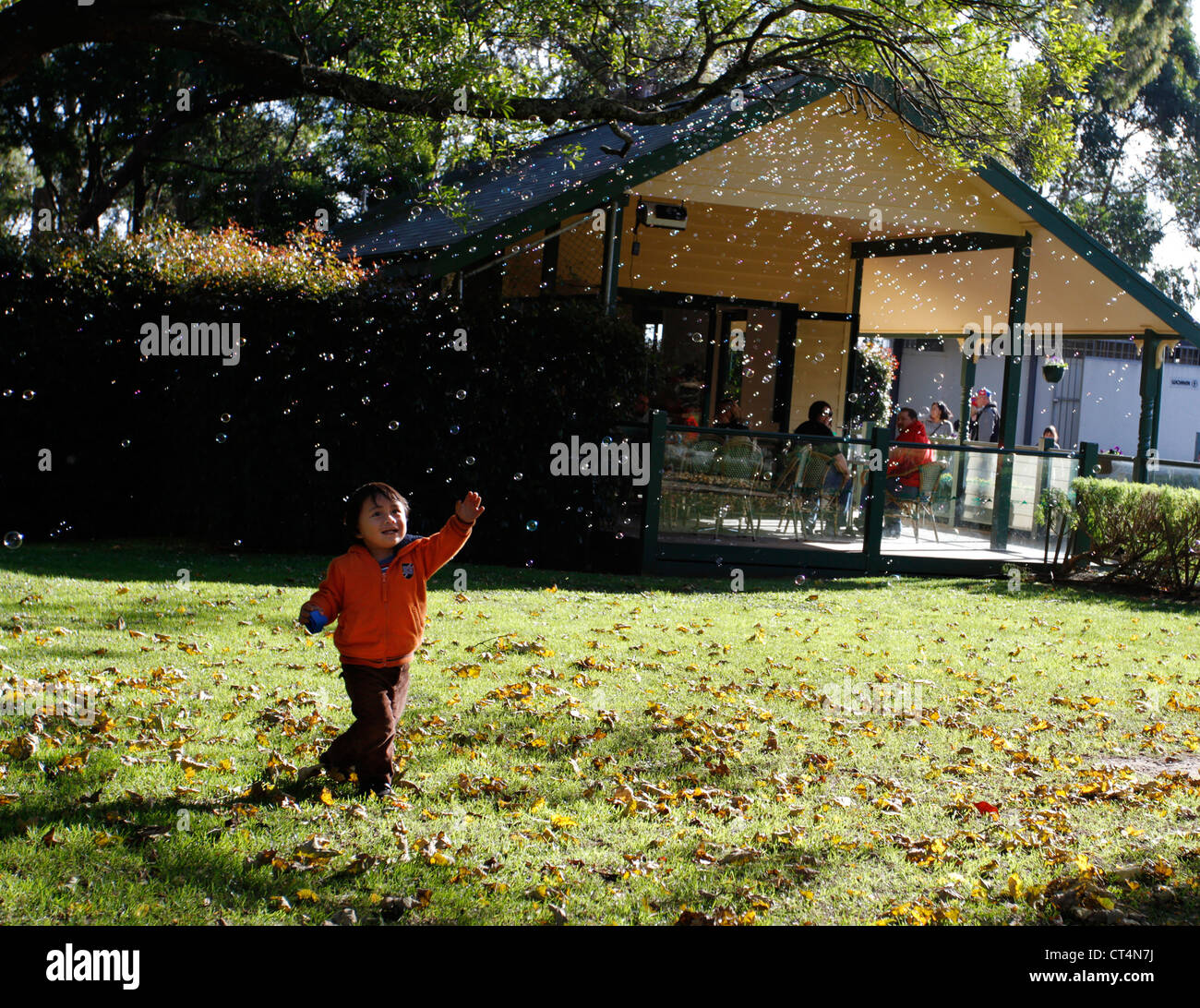 Child having fun playing with soap bubbles Stock Photo - Alamy
