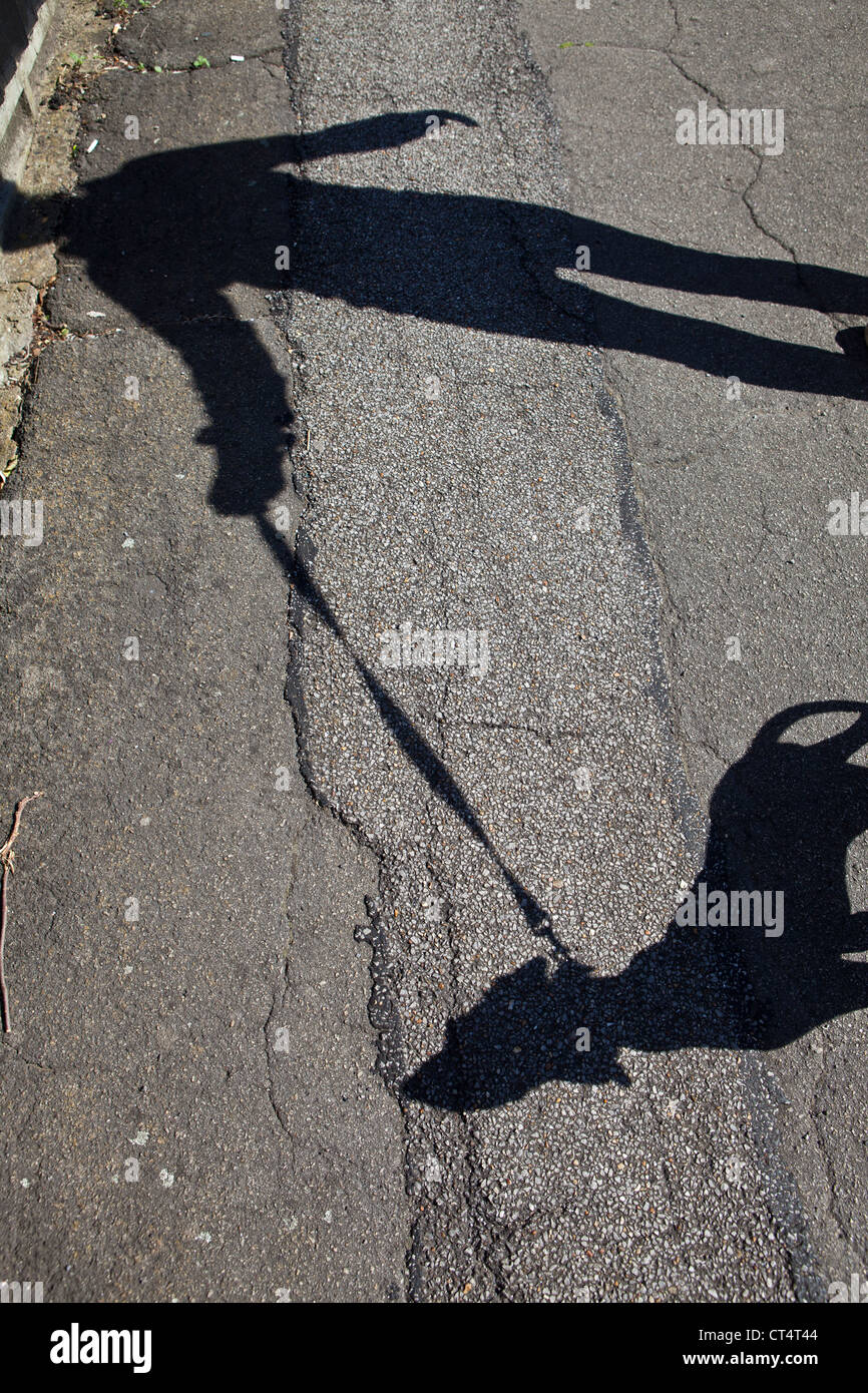 Shadows of person walking dog Stock Photo - Alamy