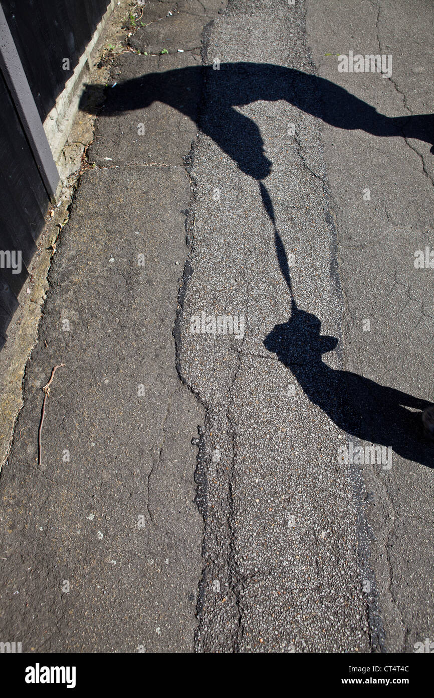 Shadows of person walking dog Stock Photo - Alamy