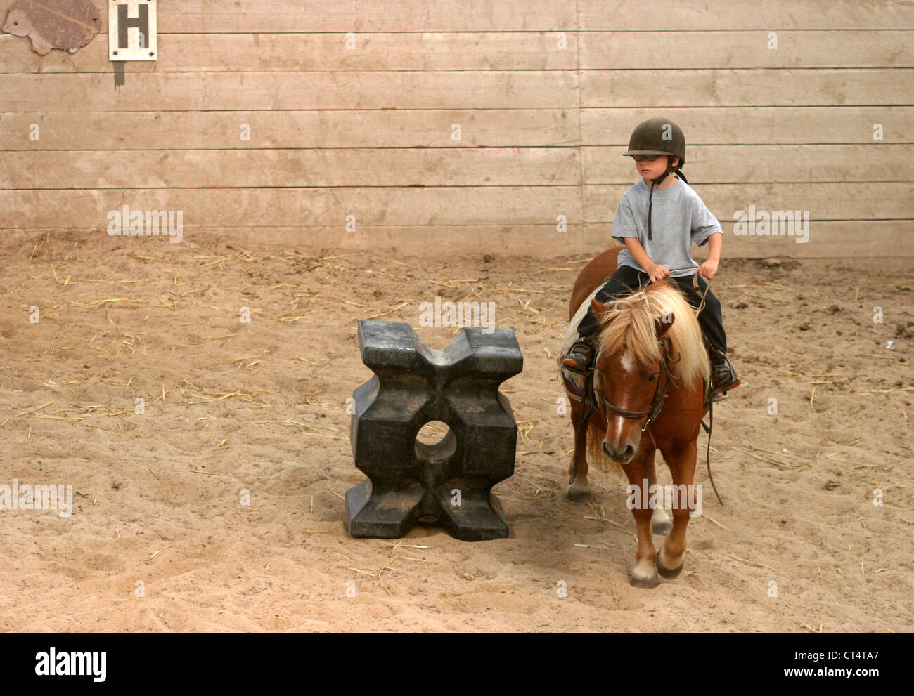Boy riding hobby horse hi-res stock photography and images - Alamy