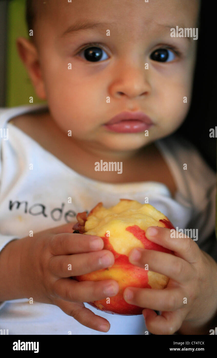 CHILD EATING FRUIT Stock Photo - Alamy
