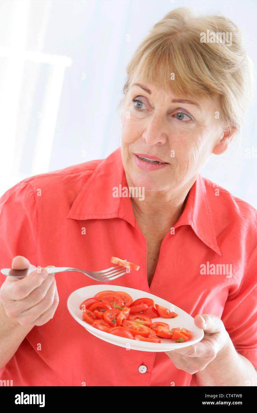 ELDERLY P. EATING RAW VEGETABLES Stock Photo - Alamy