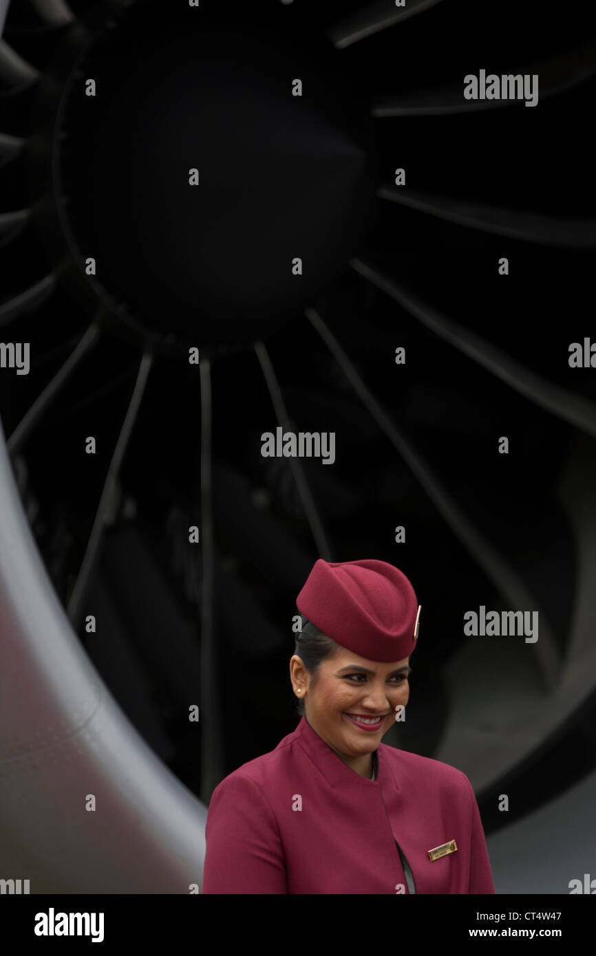 Cabin crew hostess and engine turbofan blades of a Qatar Airways Boeing ...